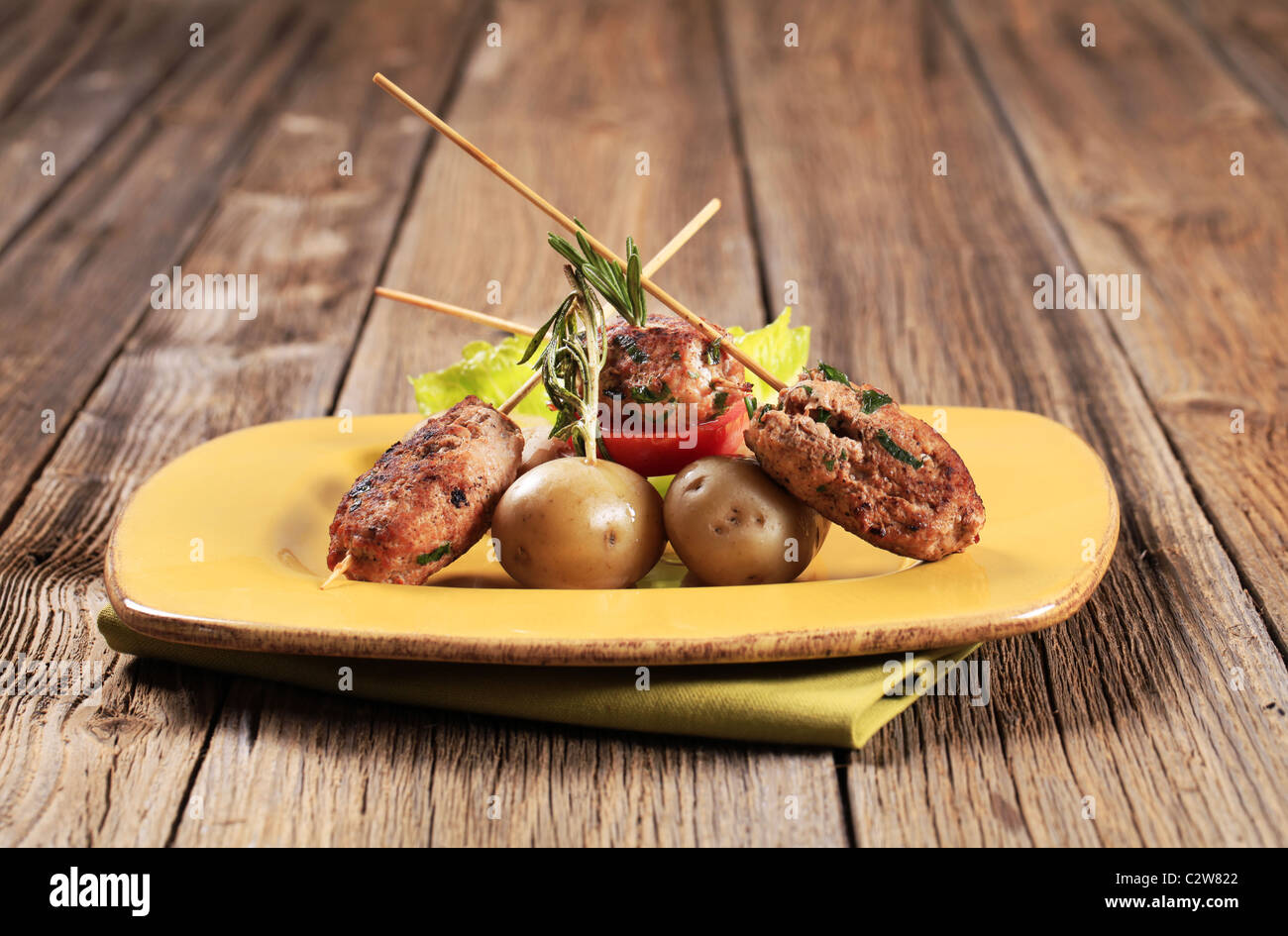 Minced meat kebabs on sticks and new potatoes Stock Photo - Alamy