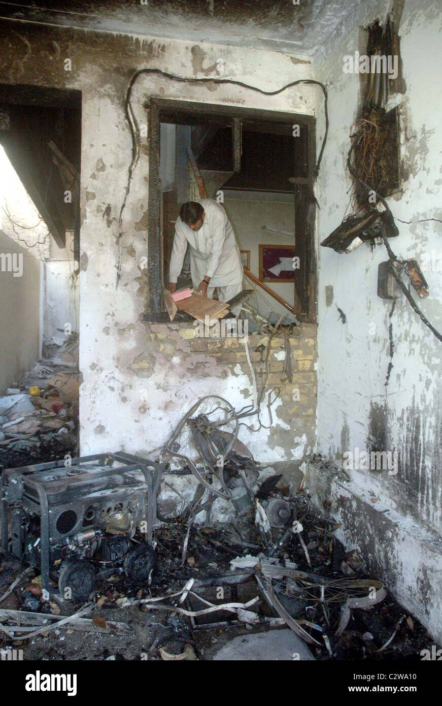 A man looks debris of a damaged building which was destroyed in ...