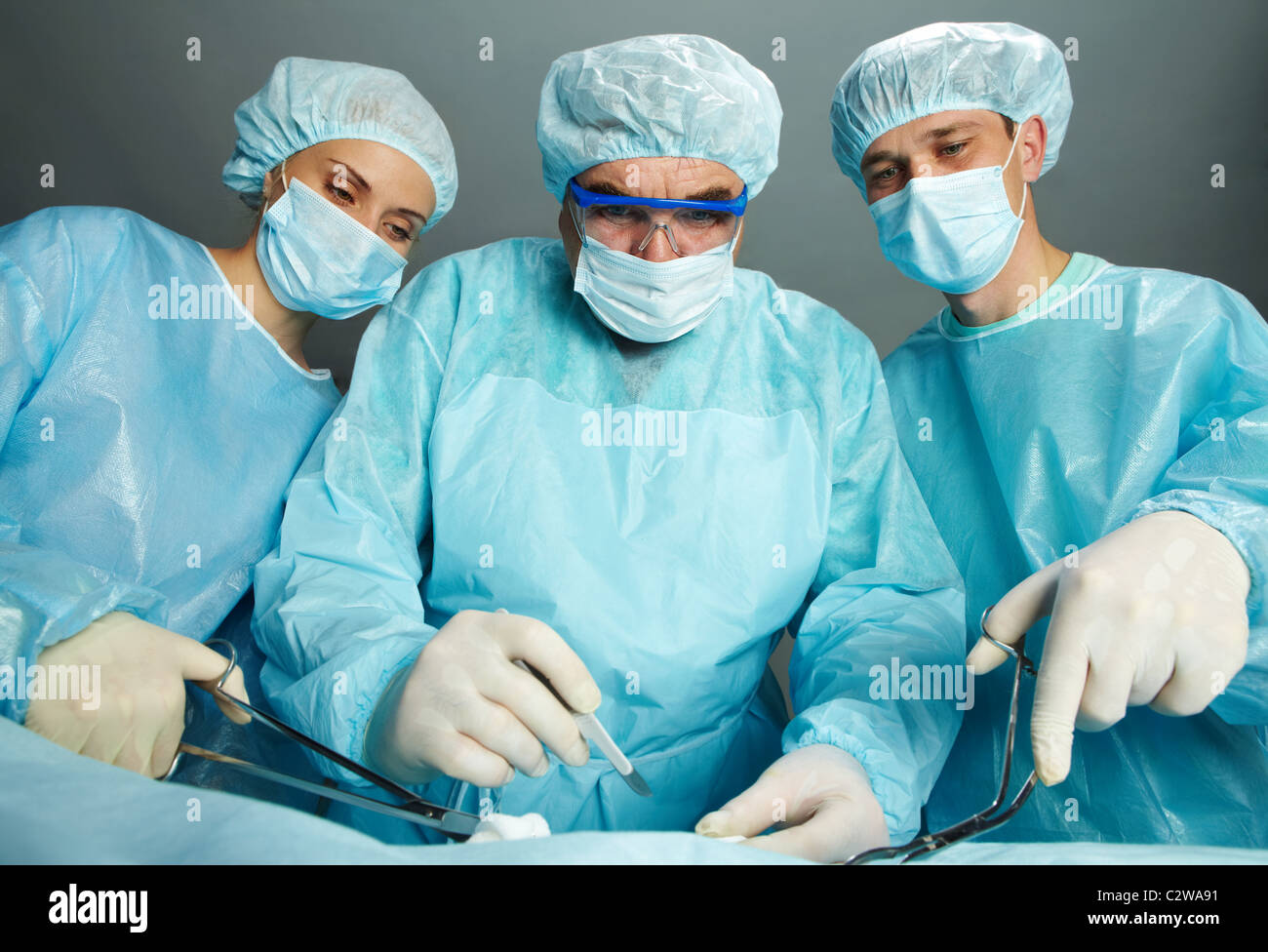 Portrait of three surgeons standing surprised Stock Photo - Alamy