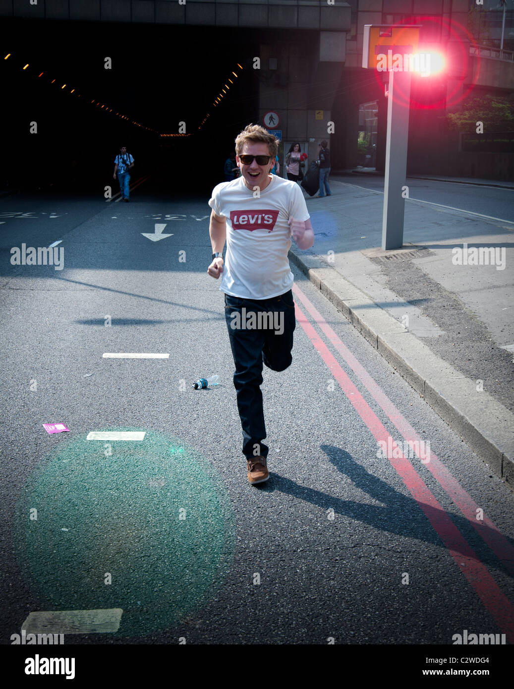 Young man running setting off speed camera Stock Photo - Alamy