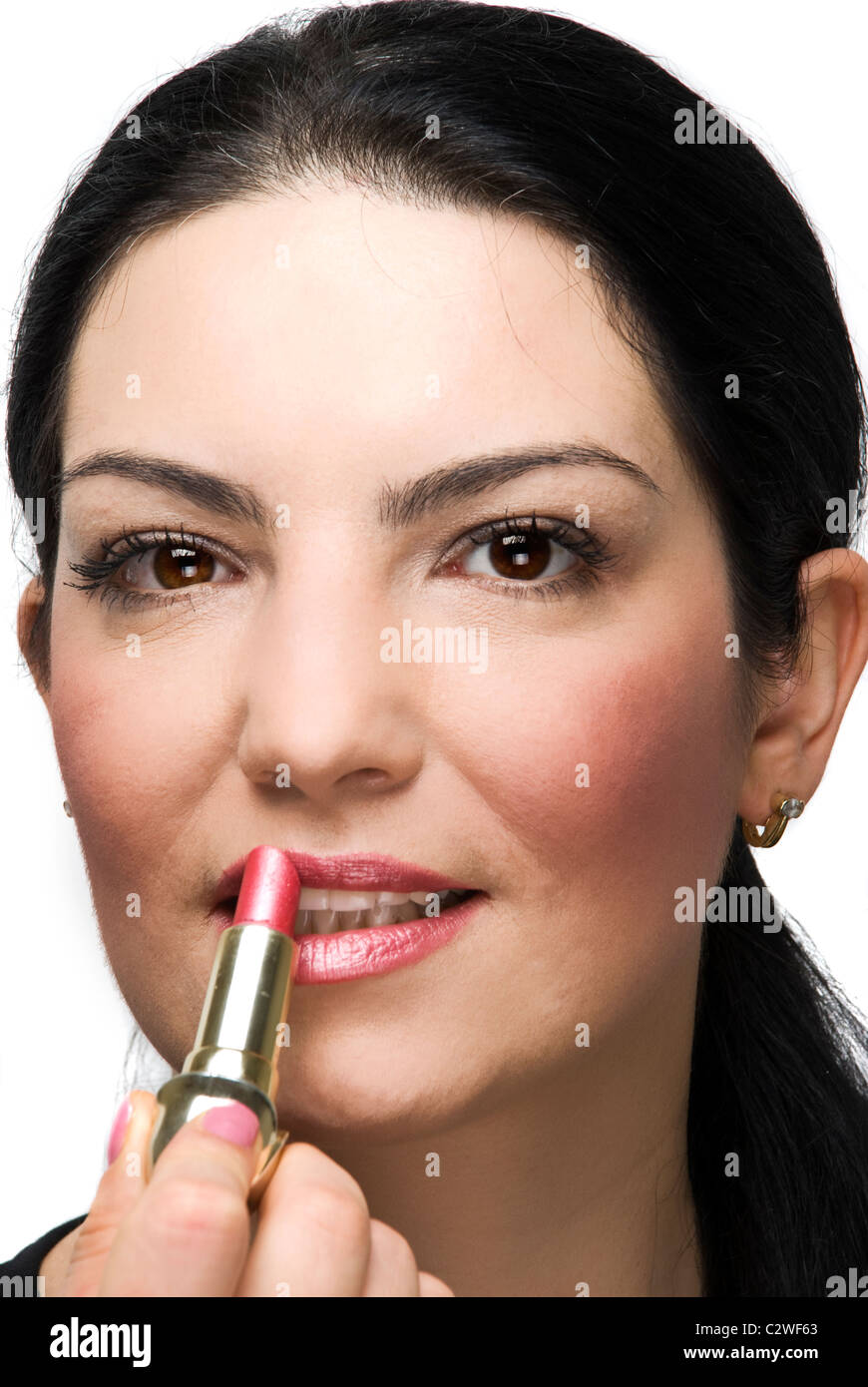 Beautiful woman applying pink lipstick isolated on white background ...