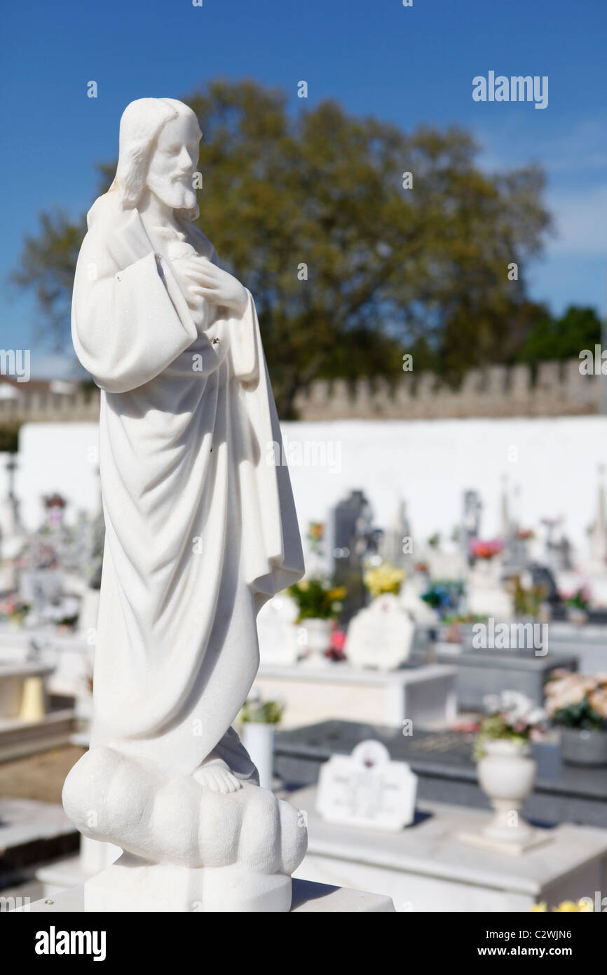 A sculpture of the preaching figure of Jesus Christ is part of a grave ...