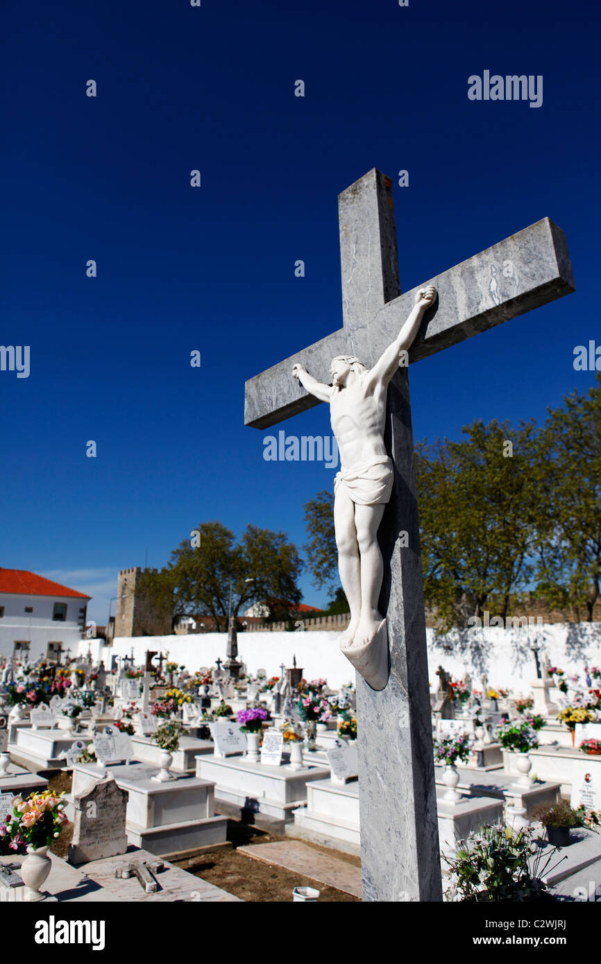A sculpture of the Jesus Christ being crucified forms part of a grave in a graveyard Stock Photo ...