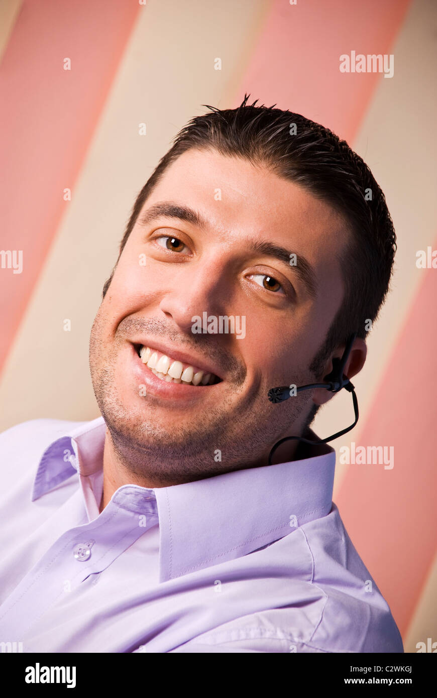 Portrait of beauty male customer service rep with headset smiling Stock ...
