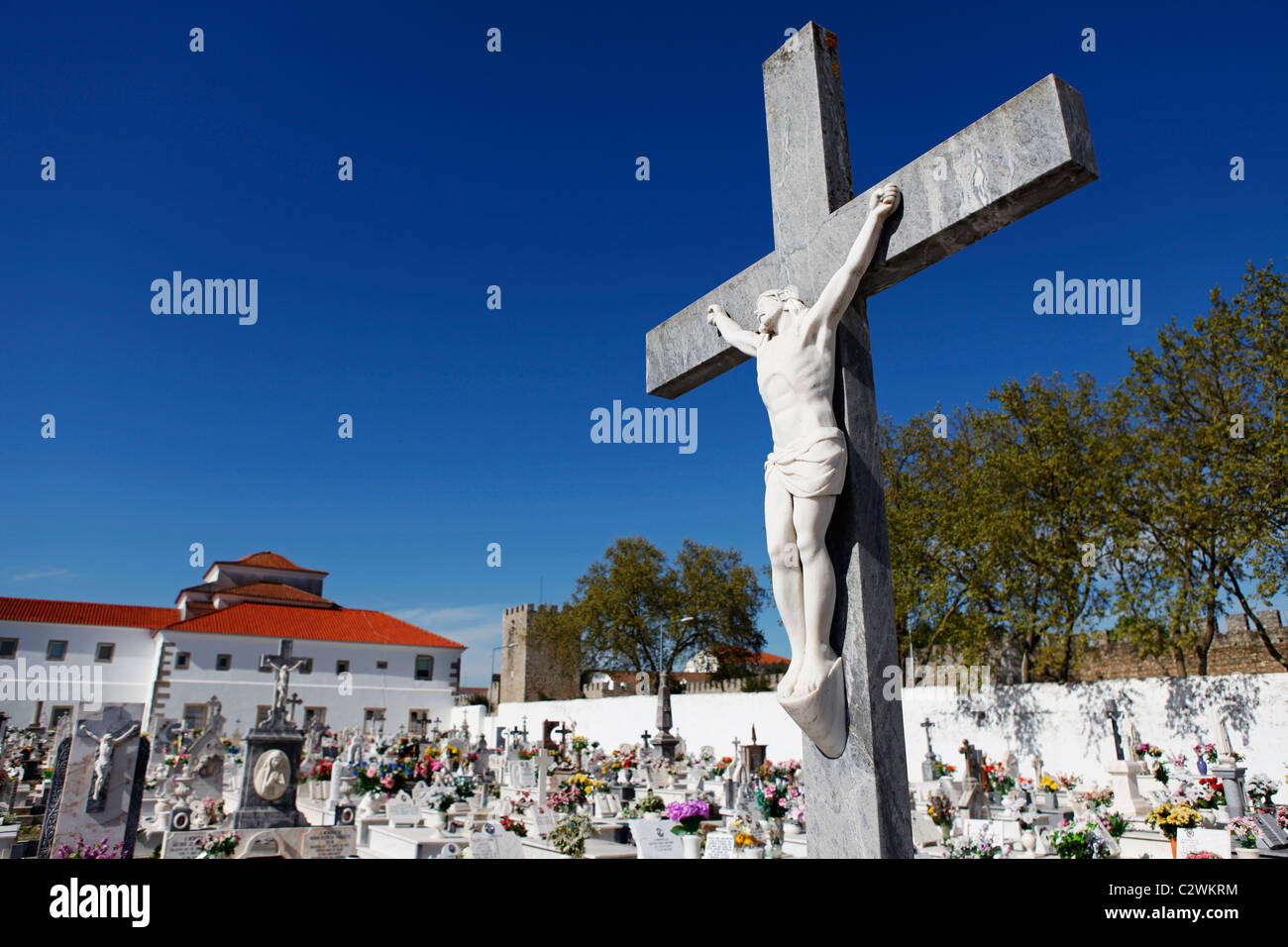 A representation of Jesus Christ on a crucifix is part of a grave in a graveyard Stock Photo - Alamy