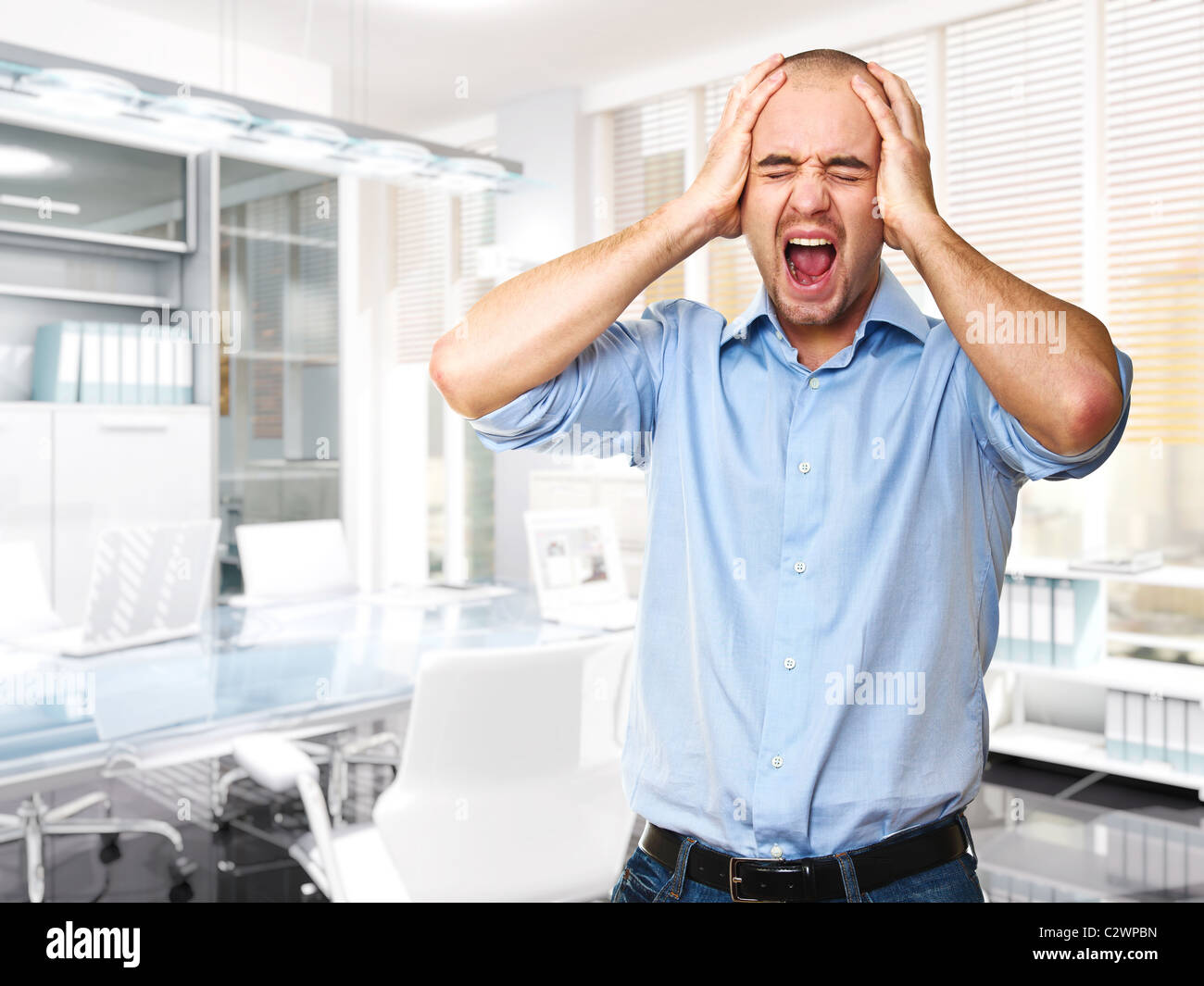 portrait of stressed caucasian worker and office background Stock Photo ...
