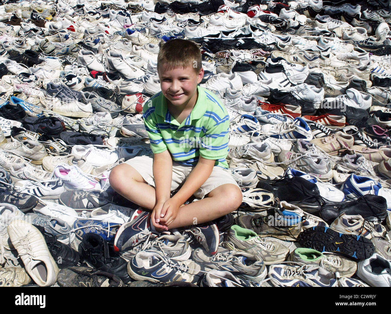 Peter Wajda sits atop a mound of 10, 512 shoes on display in the ...