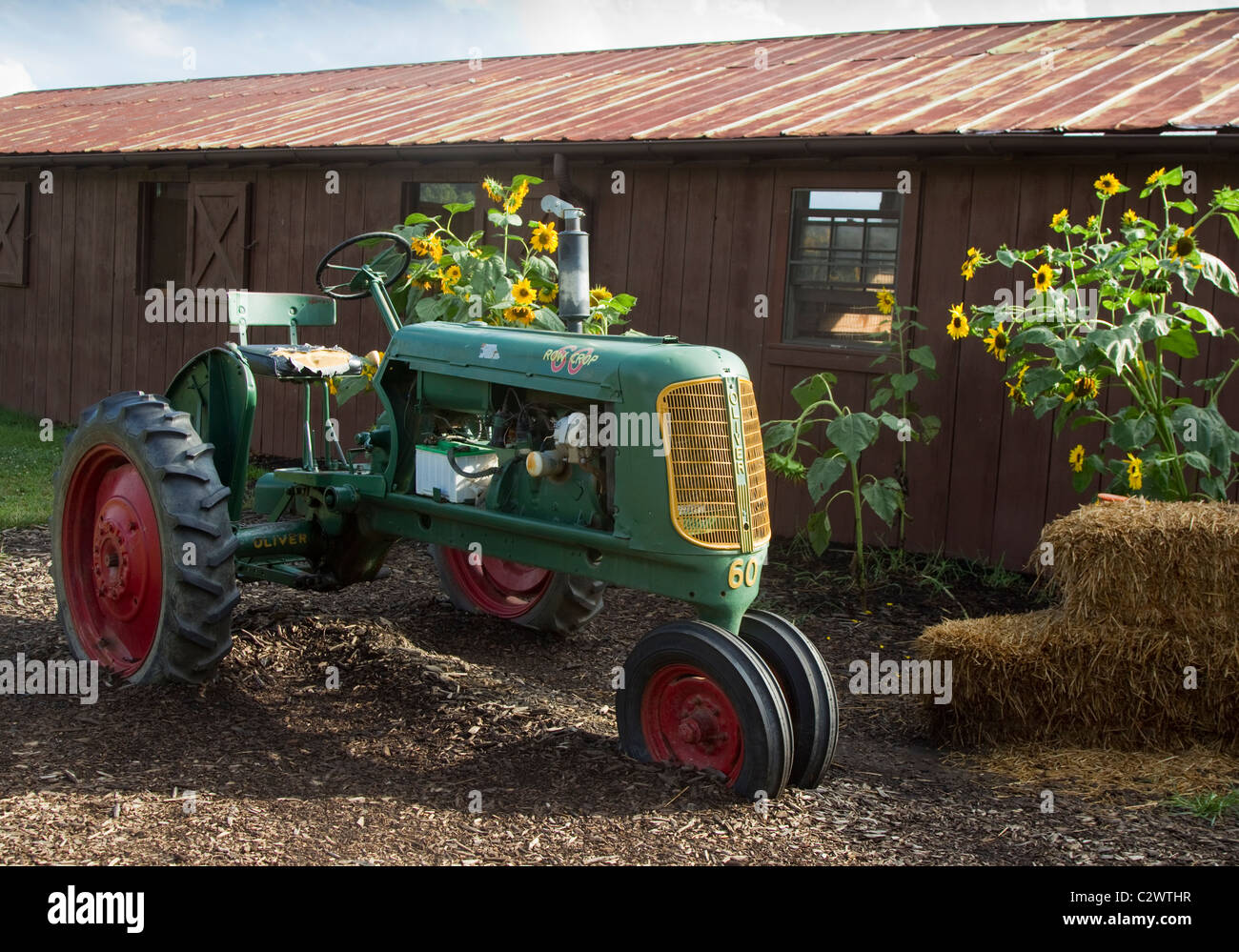An old tractor next to a barn Stock Photo - Alamy