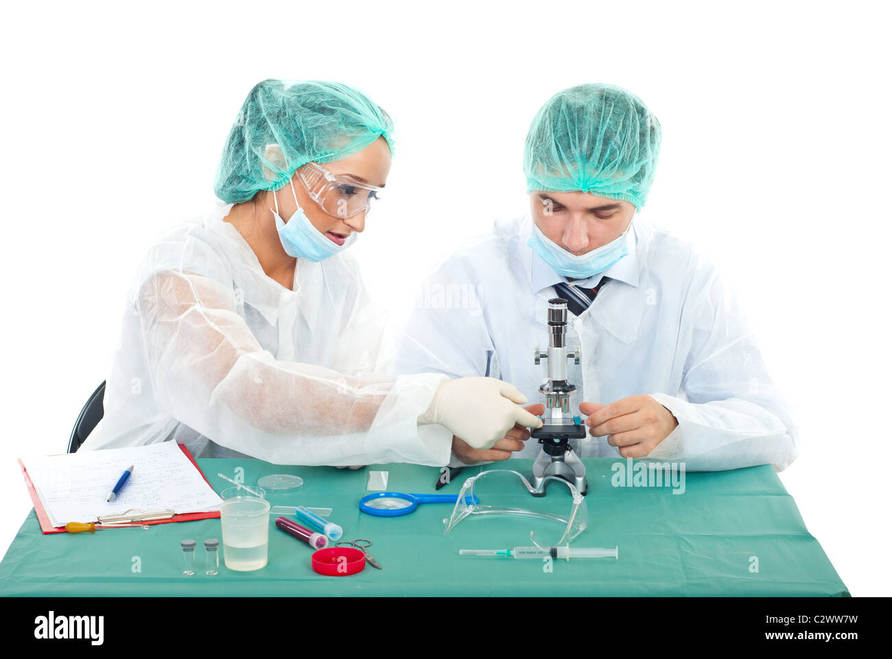 Scientist woman helping her colleague man to using microscope in ...