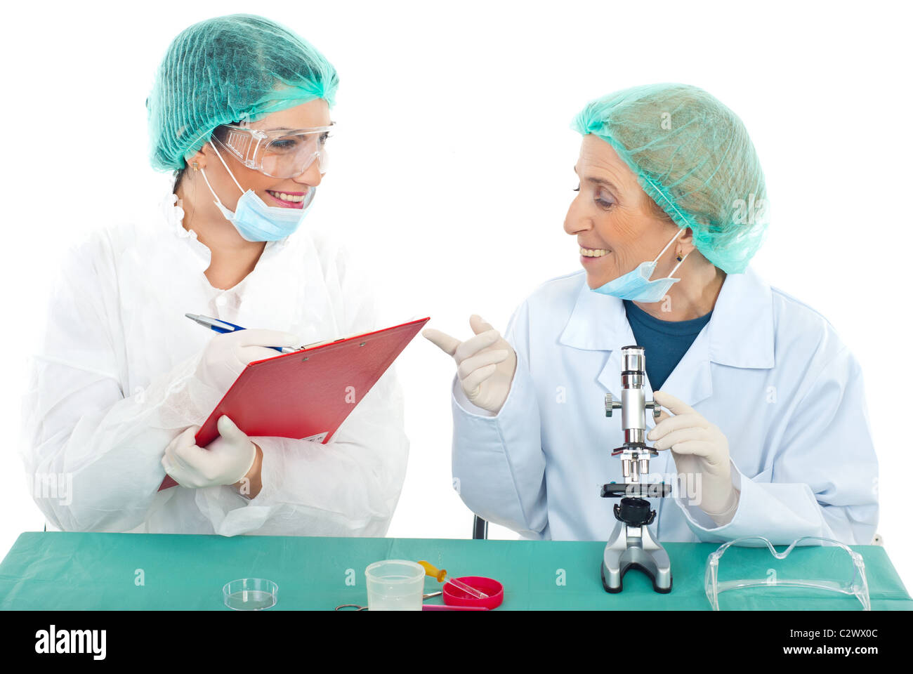 Senior teacher woman having conversation with her student in laboratory ...