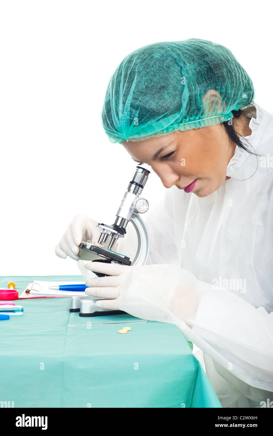 Profile of woman looking through microscope in laboratory Stock Photo ...