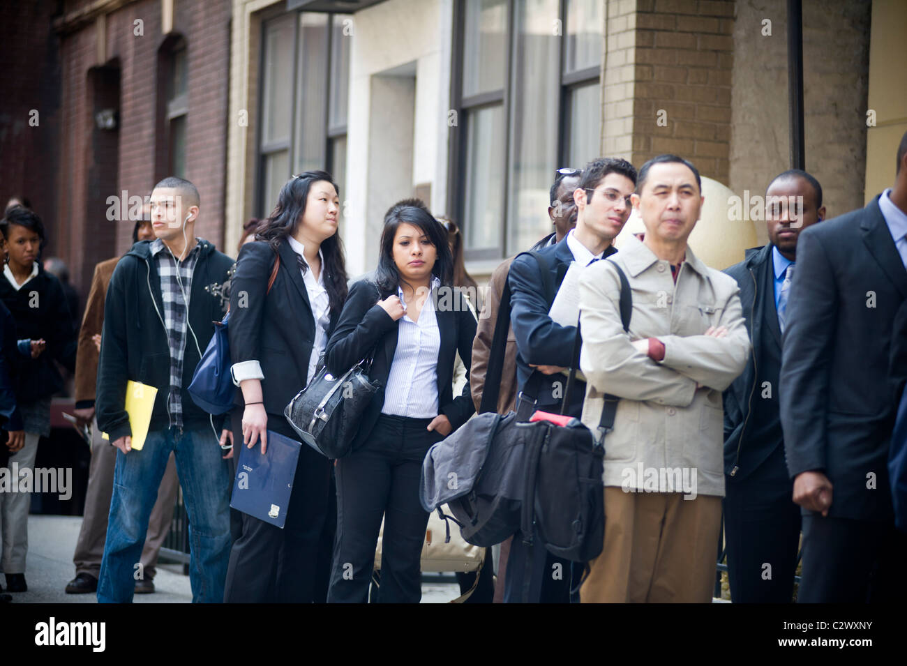 Job seekers line up for a job fair in midtown in New York on Monday ...