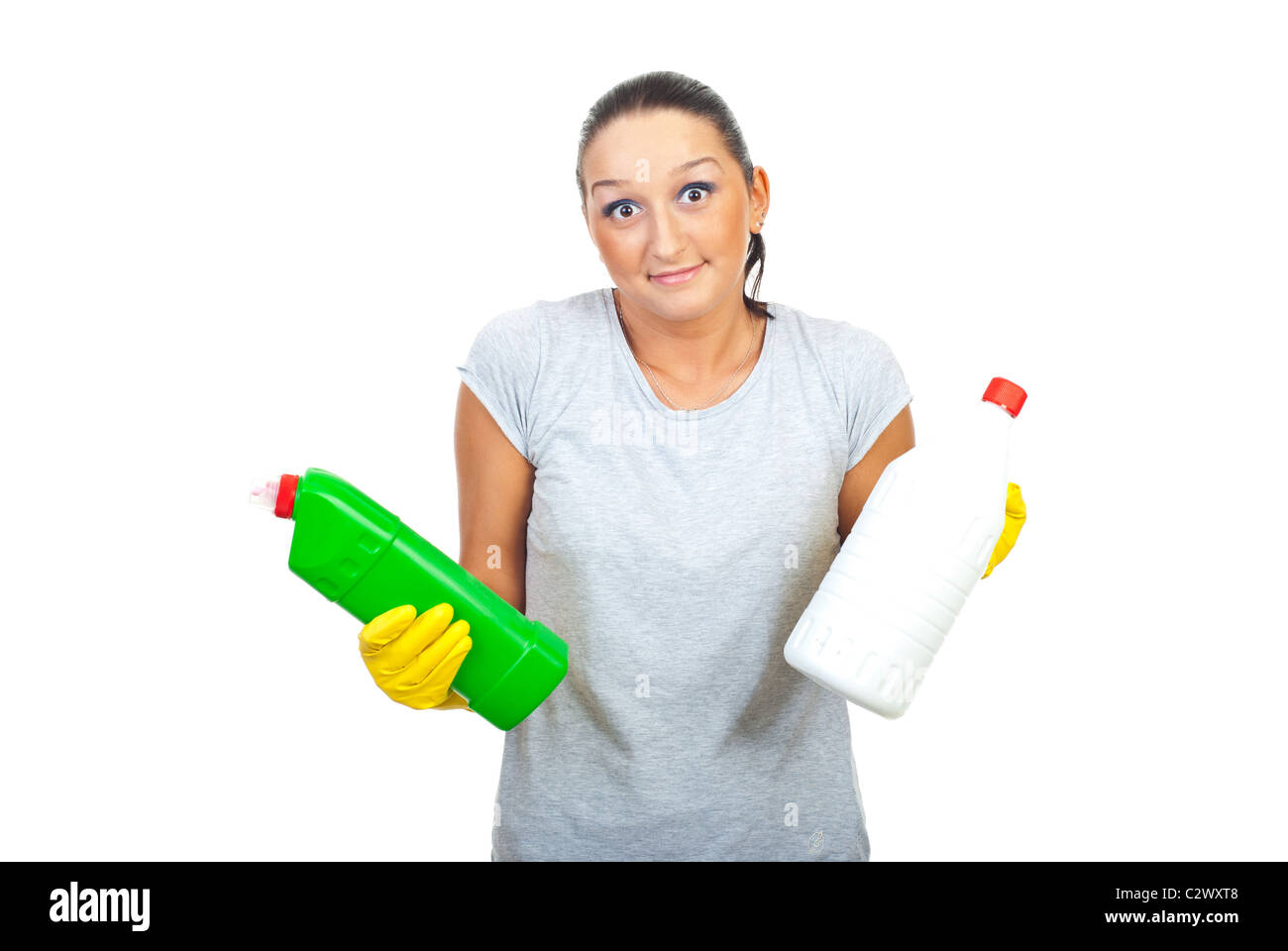 Wonder woman with grimace on face holding two types of detergents in ...