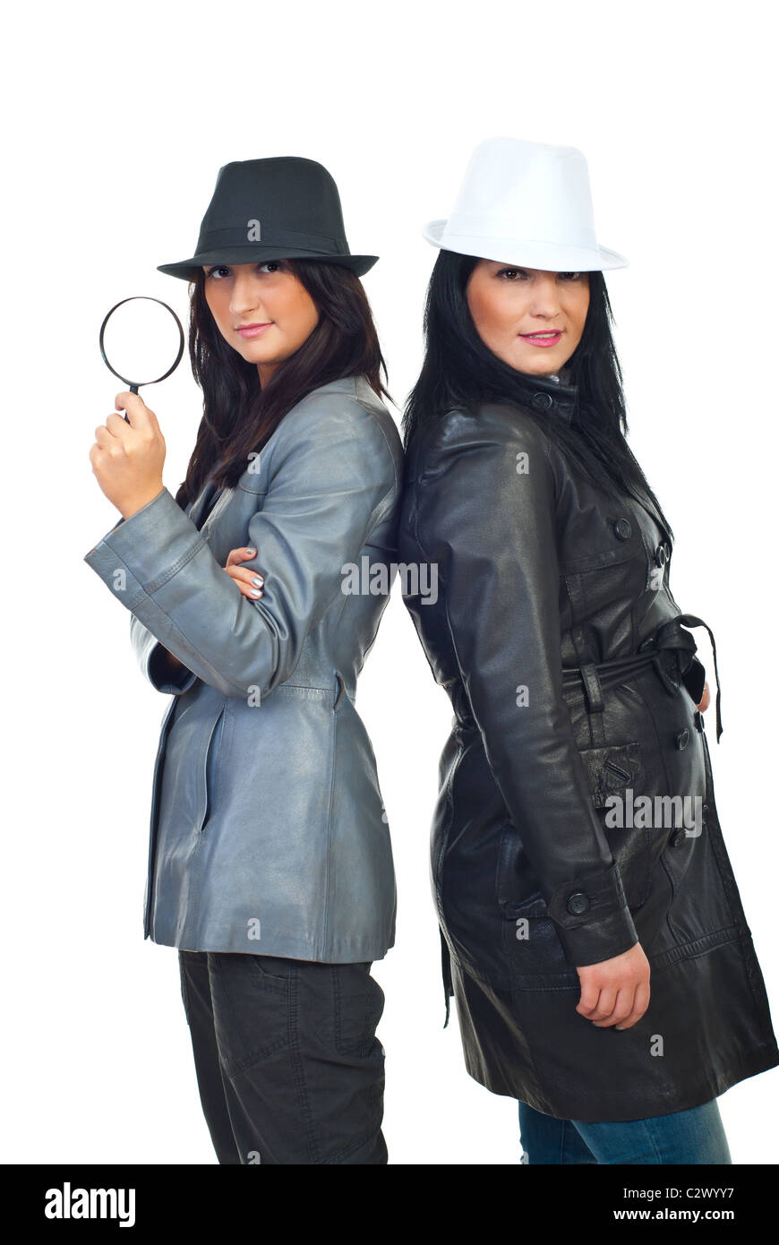 Two beautiful detectives women standing back to back and wearing hats ...