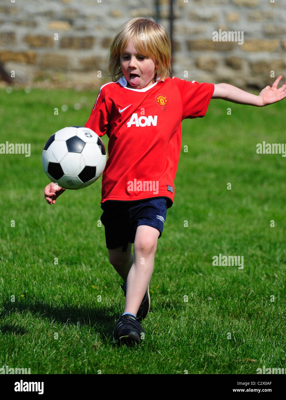 Boy playing football england uk hi-res stock photography and images - Alamy