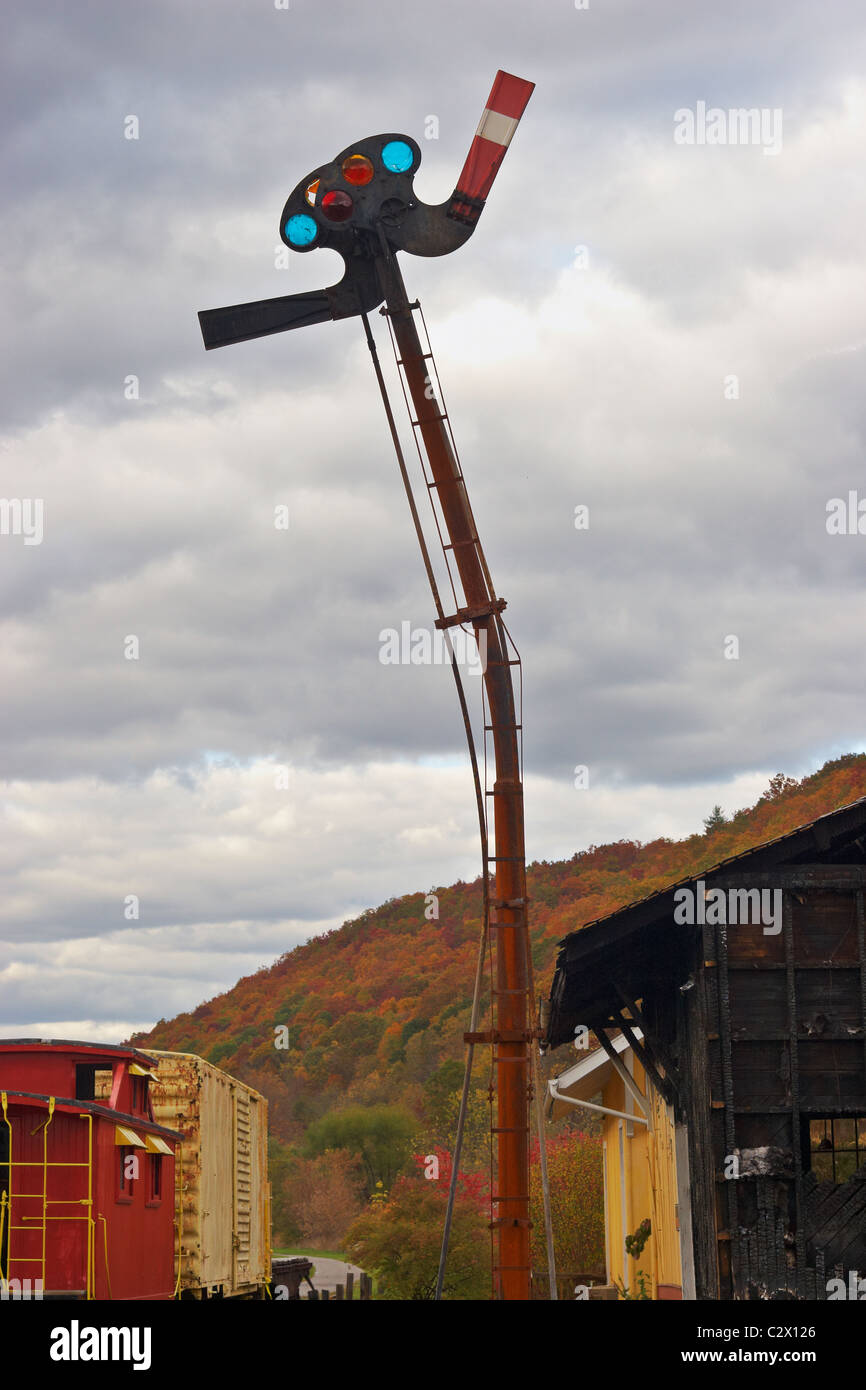 Abandoned train cars and a fire-damaged signal at a burned-out train ...