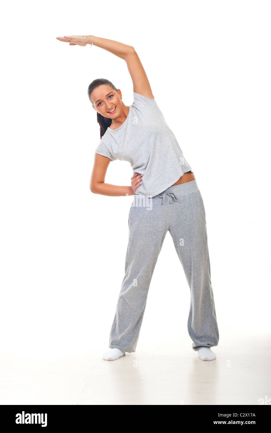 Young woman doing fitness over white background Stock Photo - Alamy