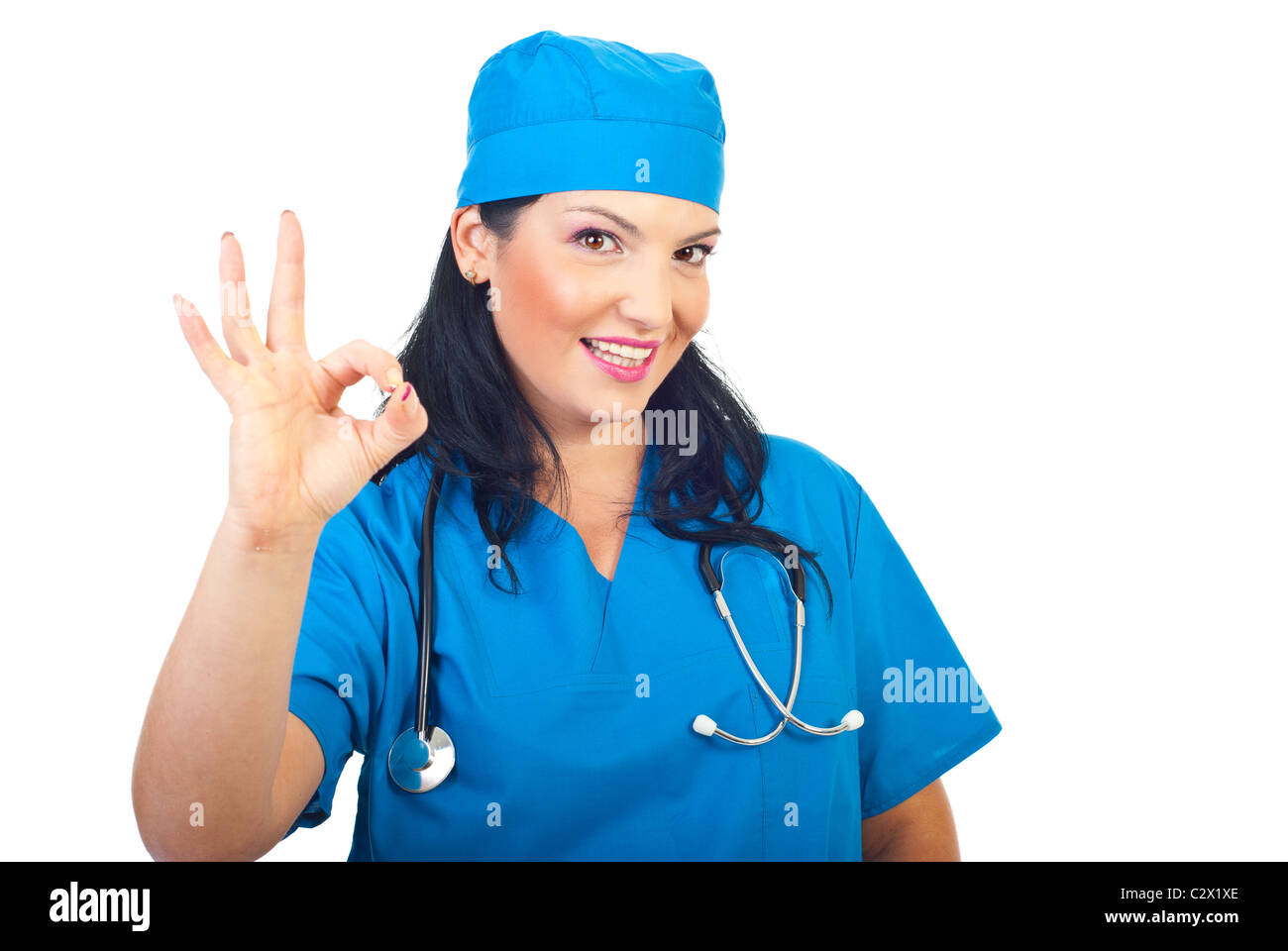 Smiling doctor woman in blue uniform with cap showing okay sign hand ...