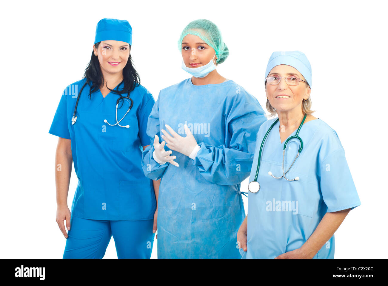 Smiling team of three different surgeons women isolated on white ...