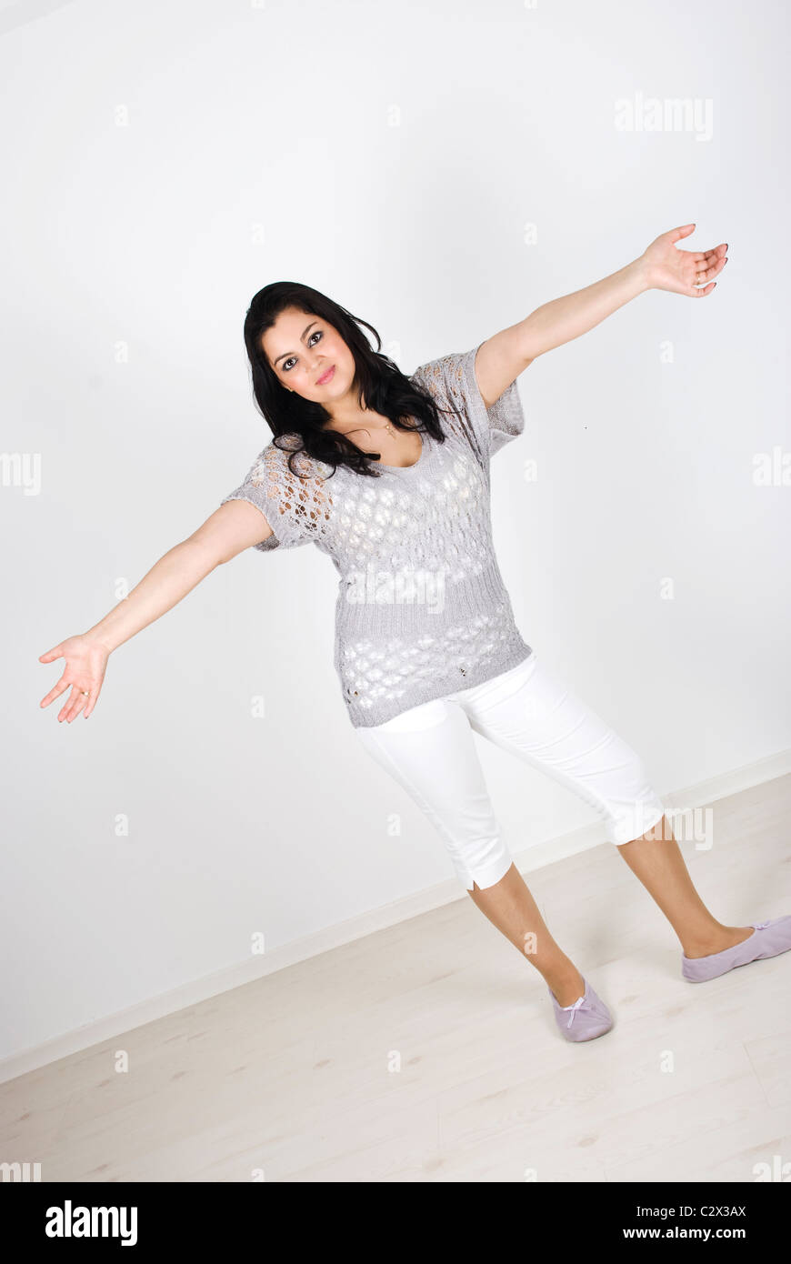 Beautiful woman full length standing with open arms in welcoming ...