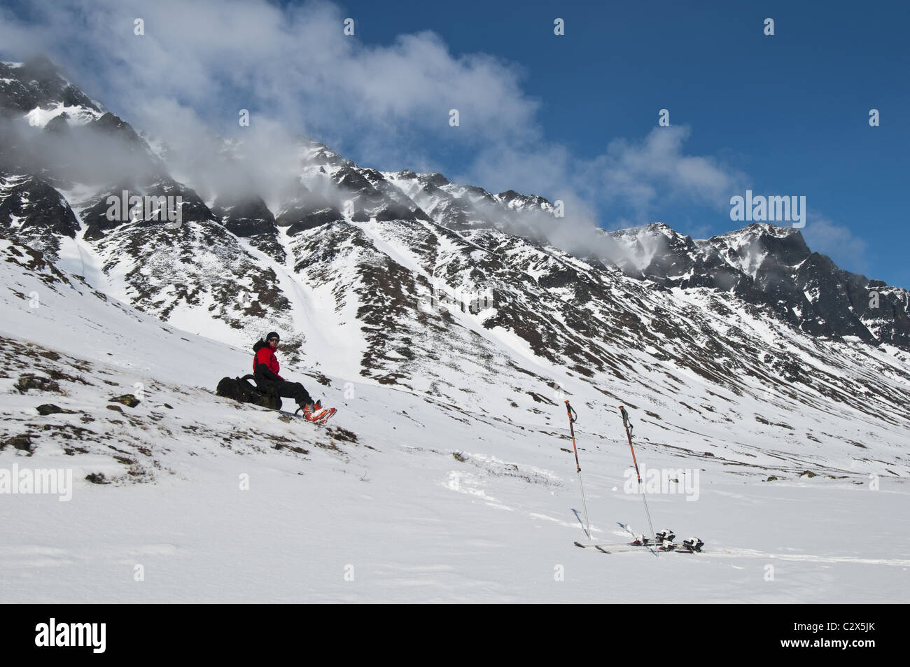 Skier resting in the snow Stock Photo - Alamy
