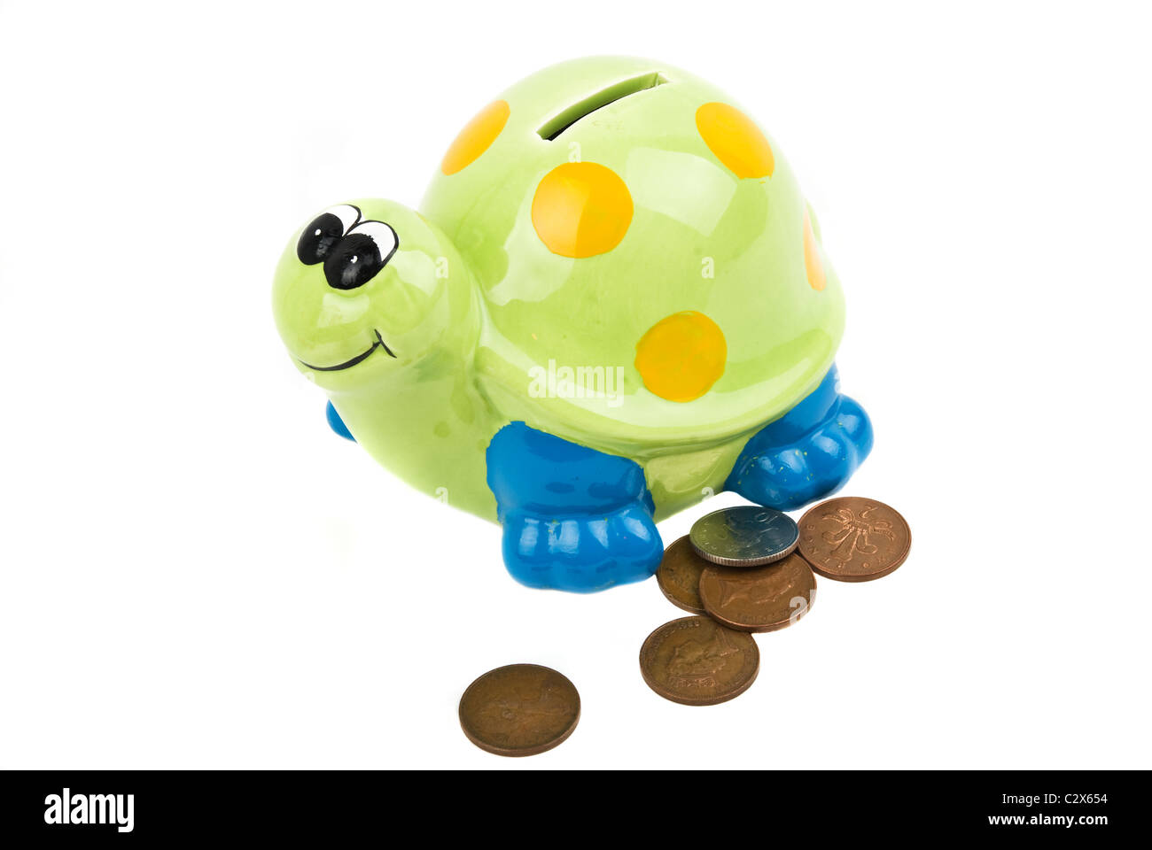 Money box tortoise with UK coins isolated on white background Stock ...