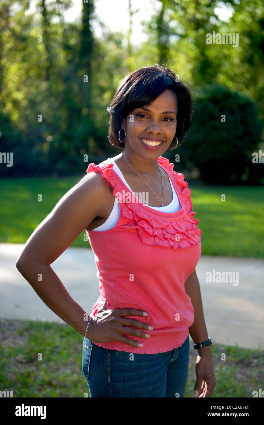 Successful black woman early 40s short black hair smiles in front of ...
