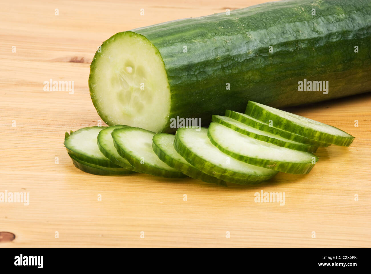 Big cucumber sliced on a wood table in kitchen Stock Photo - Alamy