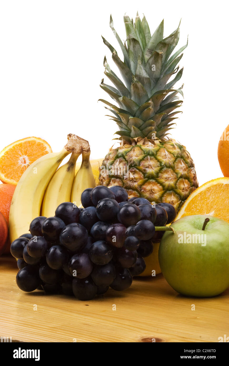 Close up of fresh fruits on wood table,black grapes in front of image ...