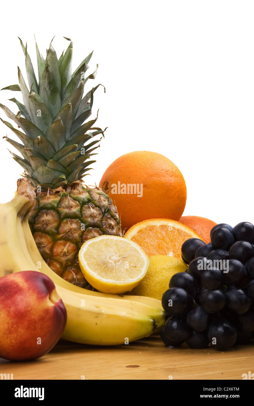 Close up of fresh fruits, whole and sliced fruit on wood table Stock ...