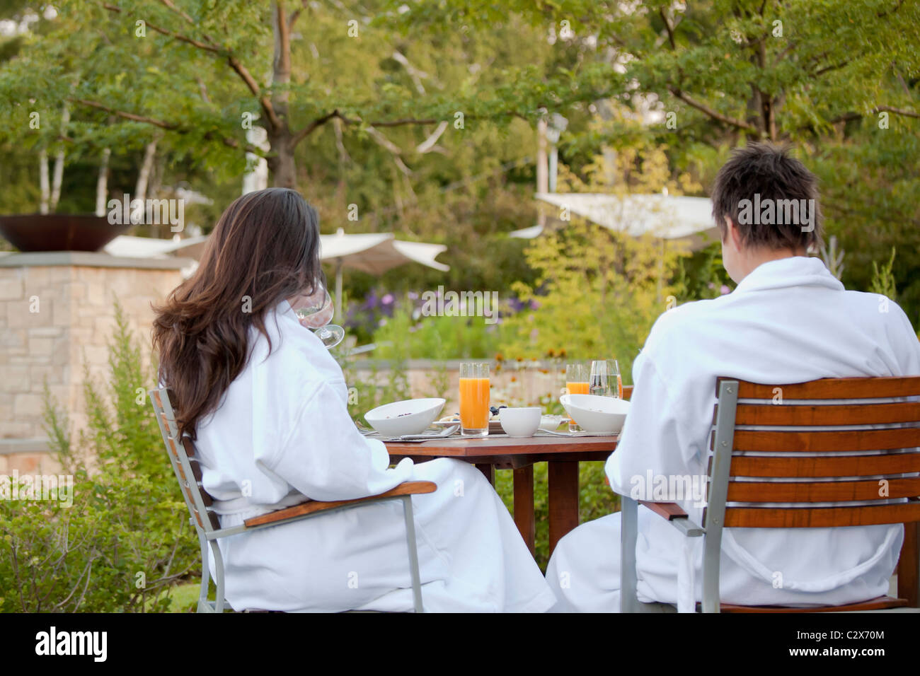 Couple enjoying breakfast on outdoor patio Stock Photo - Alamy