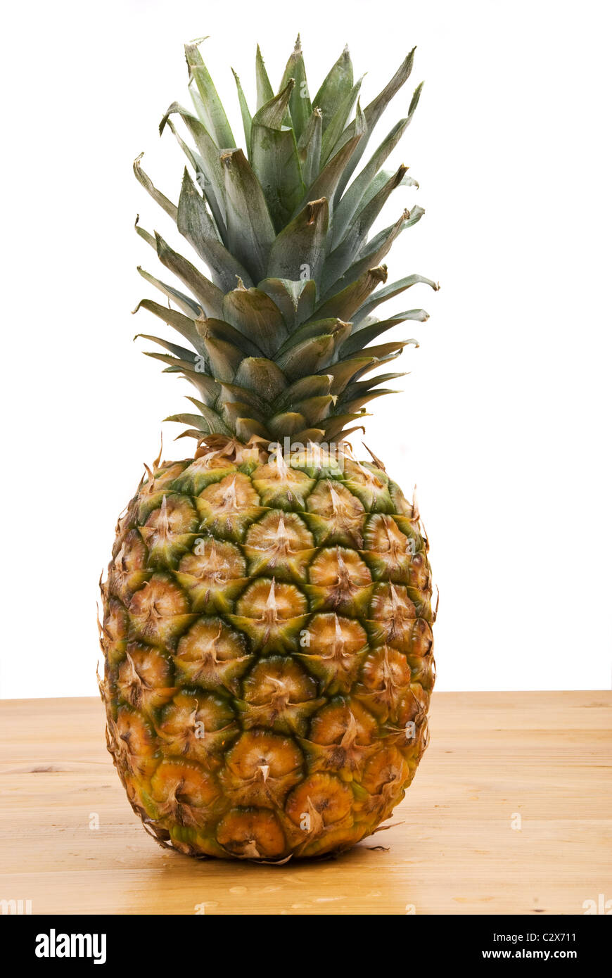 Full fresh pine-apple fruit on a wood table isolated on white ...
