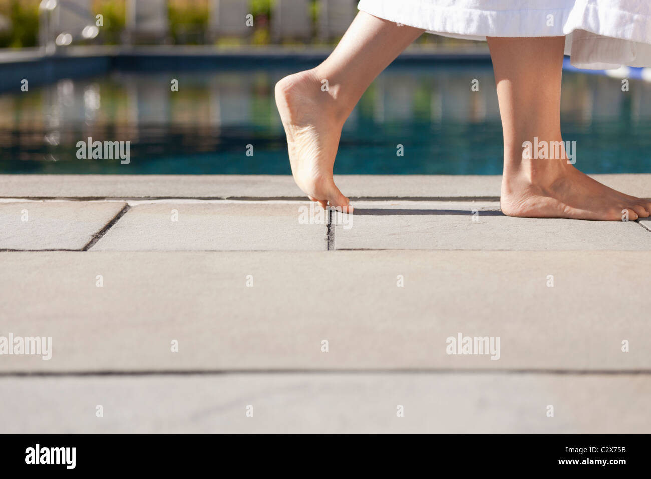 Woman walking near swimming pool Stock Photo - Alamy