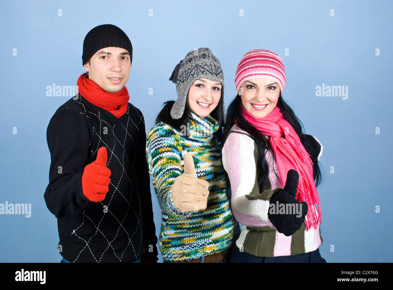 Three people smiling and standing in a line in semi profile and giving ...