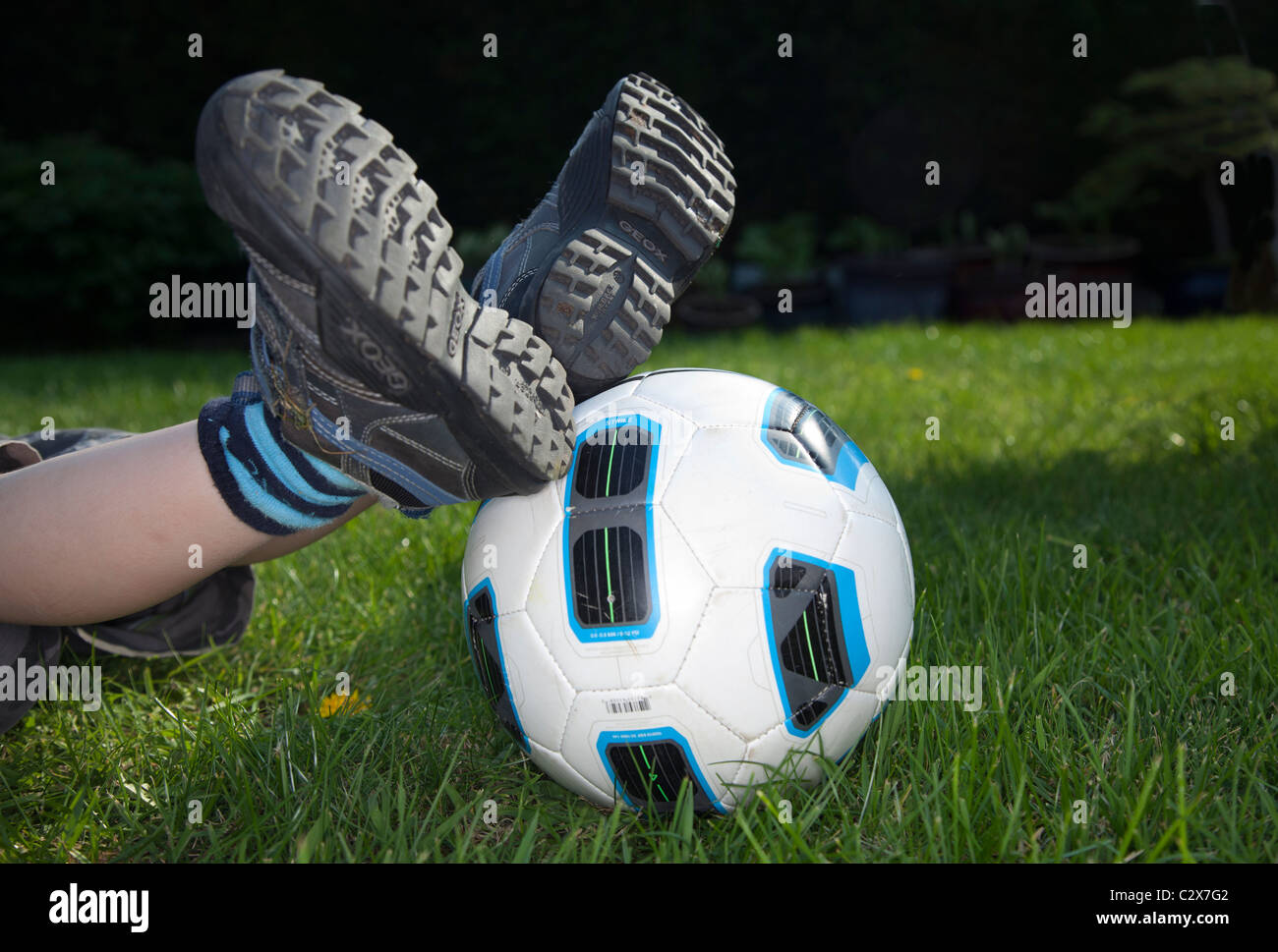 Boy with football boots hi-res stock photography and images - Alamy