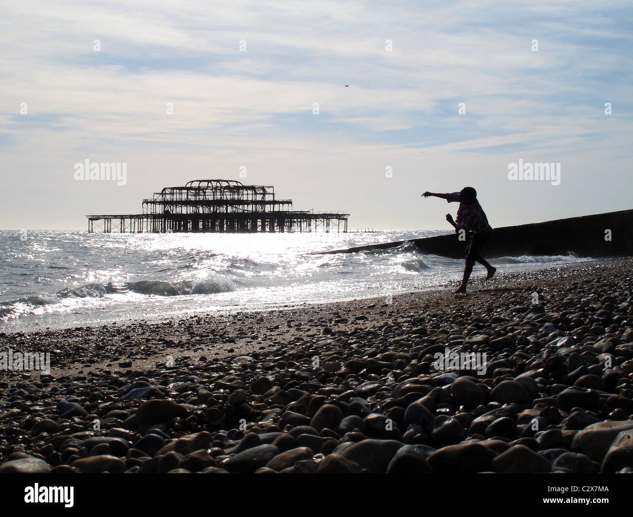 Boy throwing pebbles into the sea hi-res stock photography and images ...