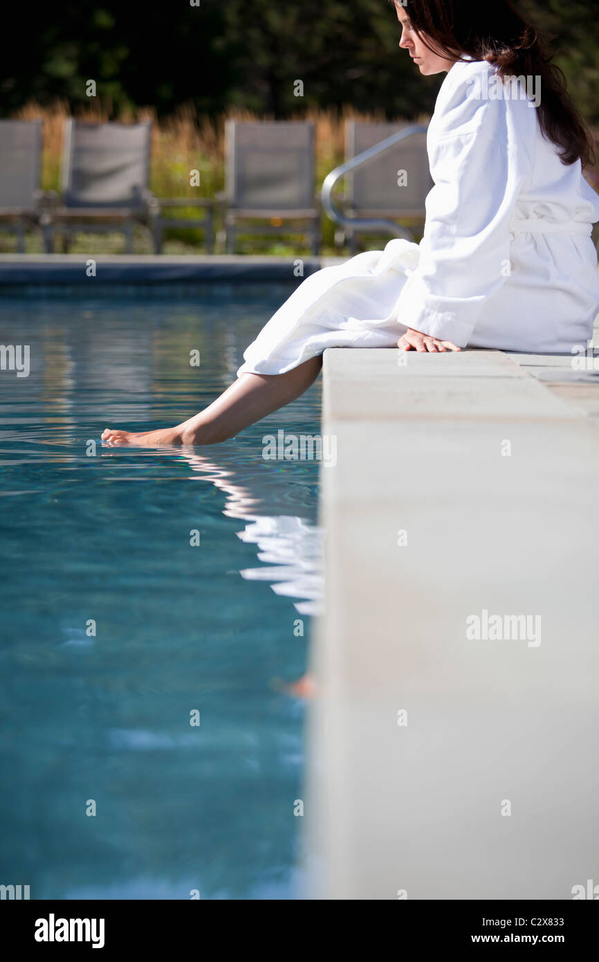 Woman soaking feet in swimming pool Stock Photo - Alamy