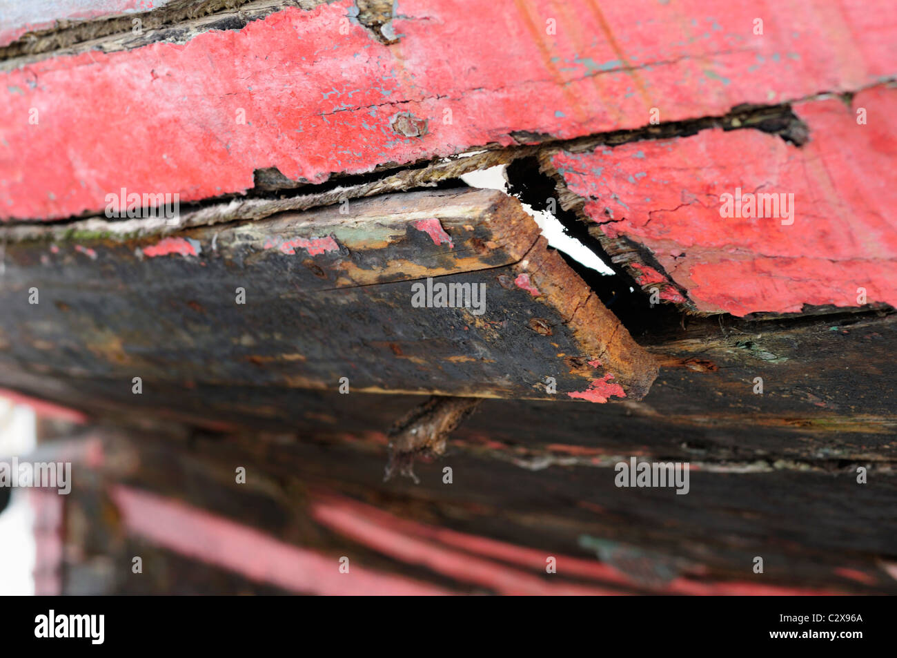 A close-up photo of a wooden boat's damaged hull, showing split wood ...