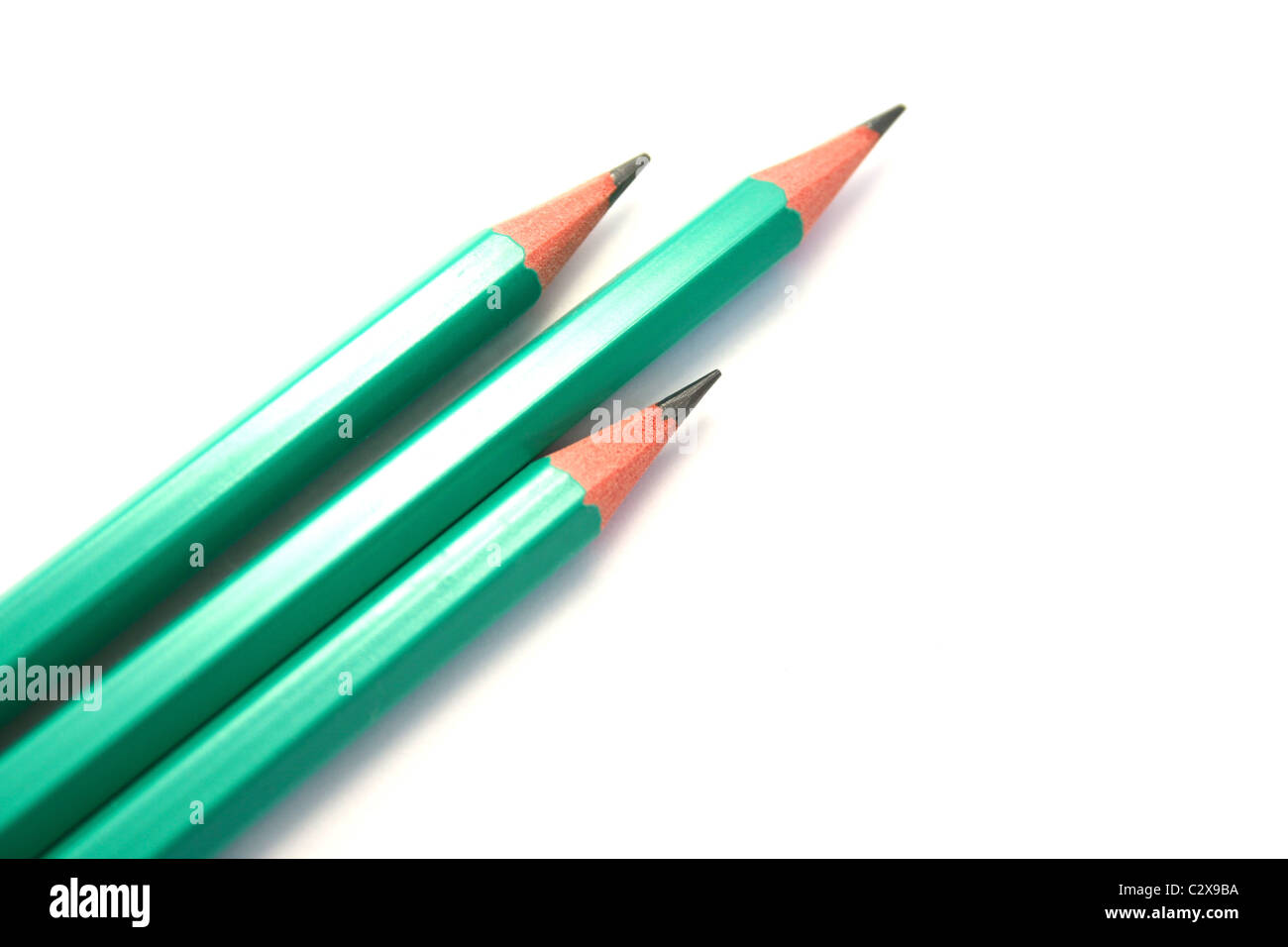 Three pencils on white background Stock Photo - Alamy