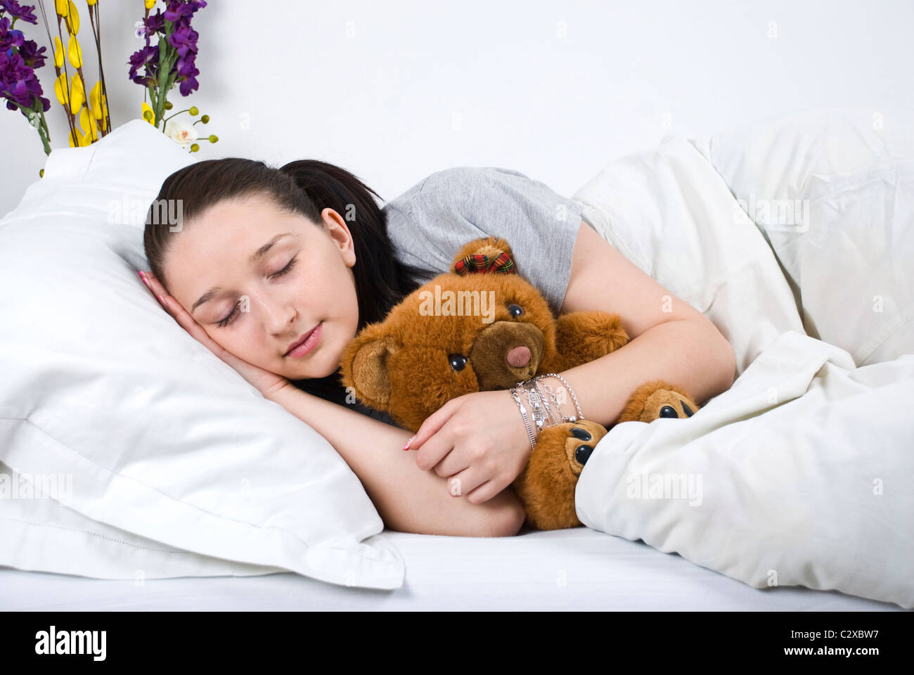 Beauty woman sleeping and hugging her teddy bear Stock Photo - Alamy