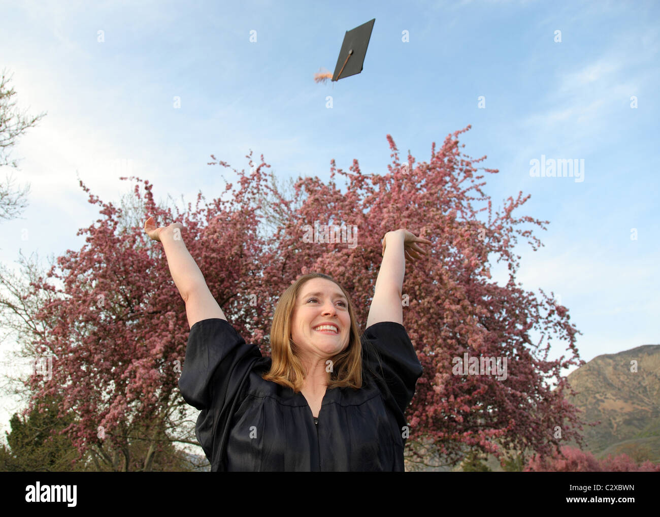 happy college graduate throwing cap into air Stock Photo - Alamy