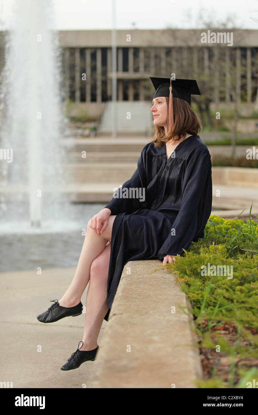 female college graduate sitting at campus full-length Stock Photo - Alamy