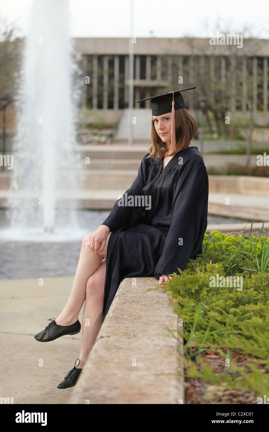full-length female college graduate sitting at campus Stock Photo - Alamy