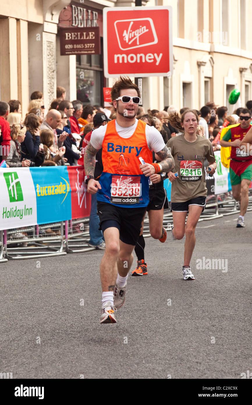 Runners at the London marathon 2011,Church street, Greenwich London ...
