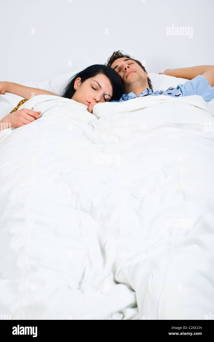 Young couple sleeping on bed ,woman rest her head on his shoulder Stock ...