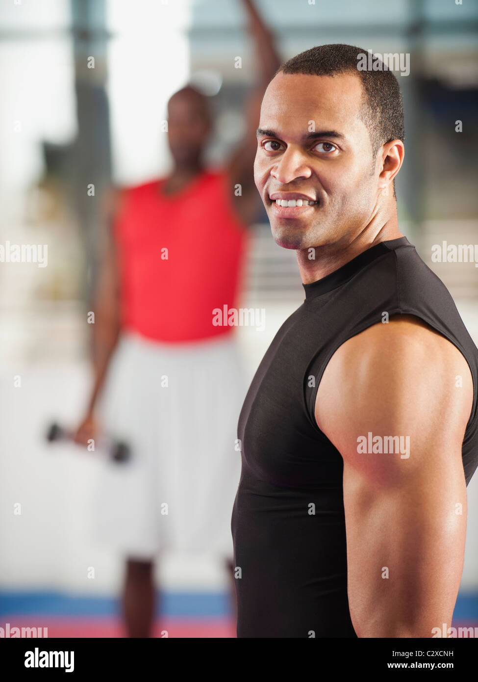 Mixed race man exercising in health club Stock Photo - Alamy