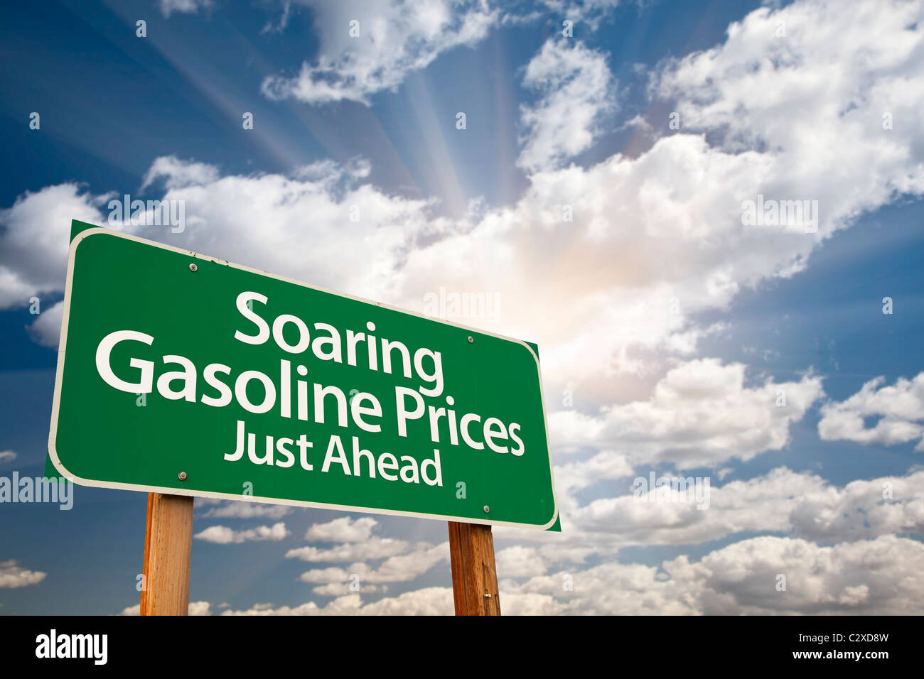 Soaring Gasoline Prices Green Road Sign with Dramatic Clouds, Sun Rays ...