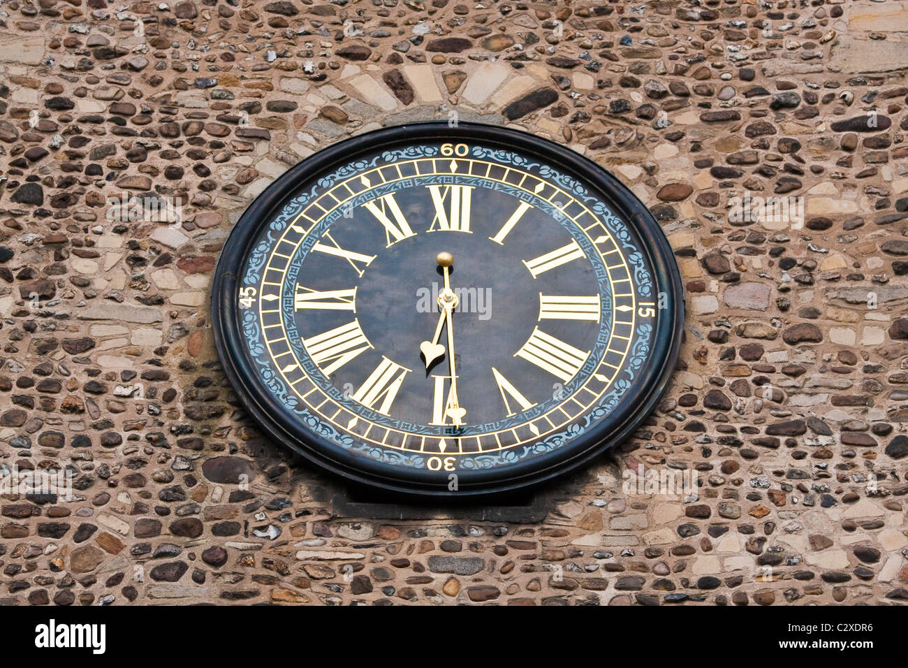 Clock on a stone wall Stock Photo - Alamy