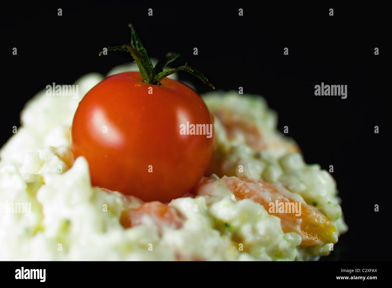 Vegetable risotto with cheese sauce and small red tomato Stock Photo ...