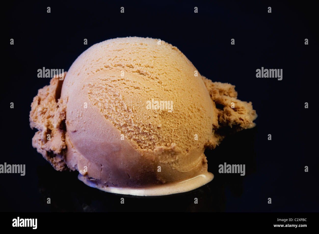 Ice cram scoop on black reflective background Stock Photo - Alamy